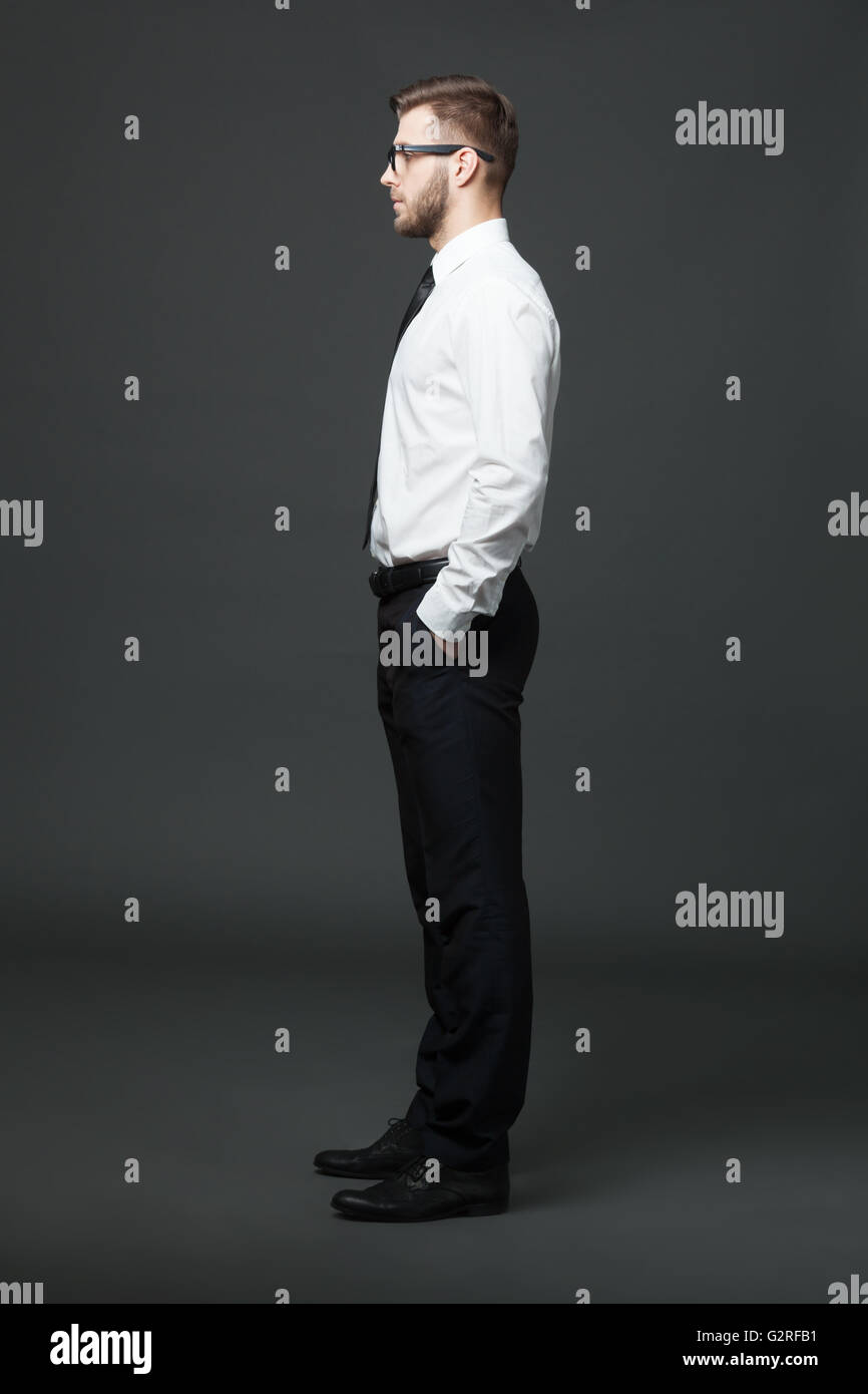 Young man standing full length profile hi-res stock photography and ...