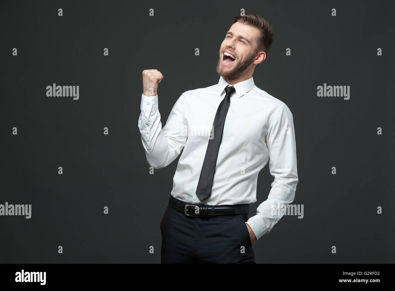 Yeah! The victory is mine! Handsome young businessman celebrating his ...