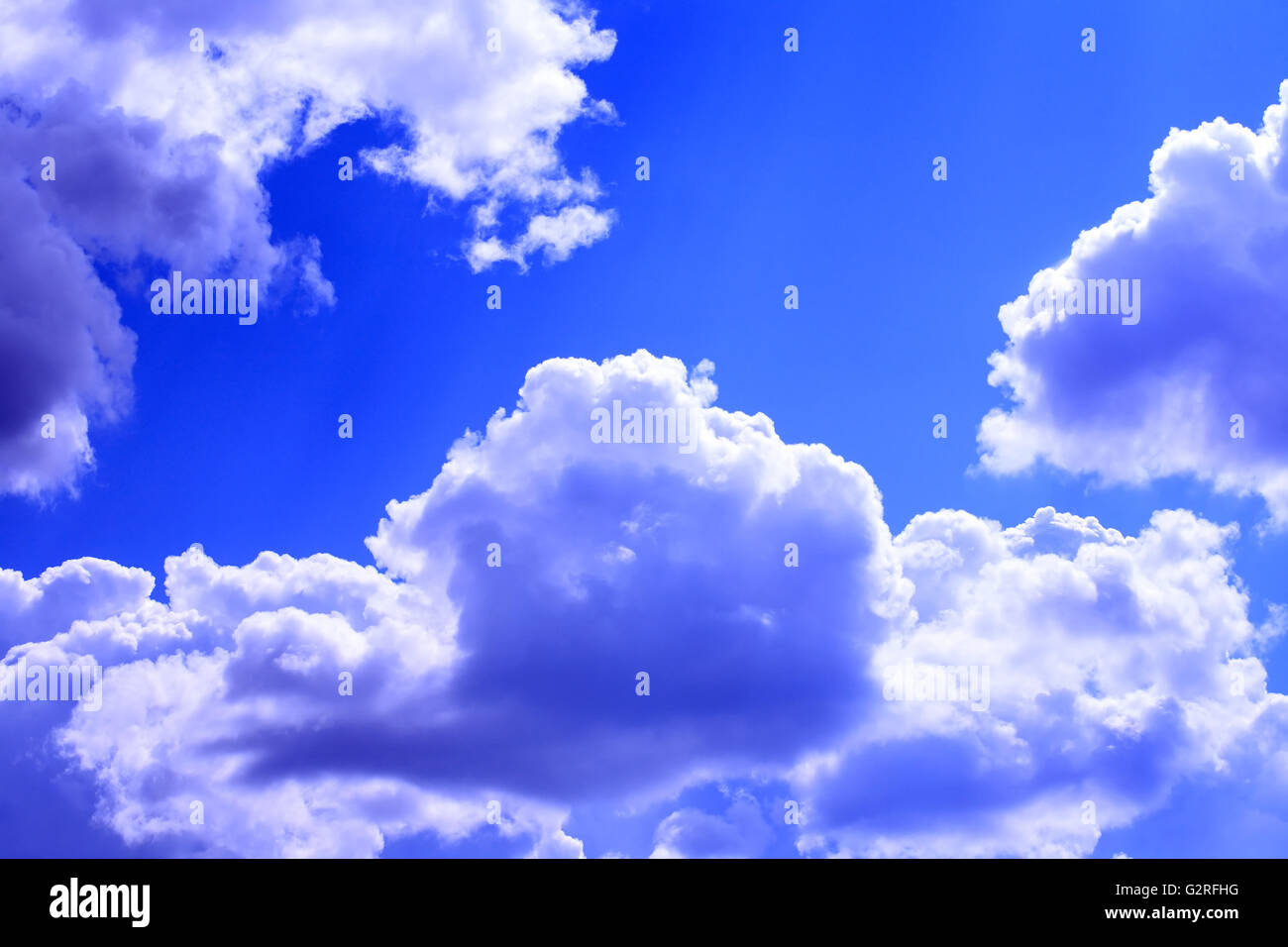 Nature background. Few big white clouds in blue sky Stock Photo - Alamy