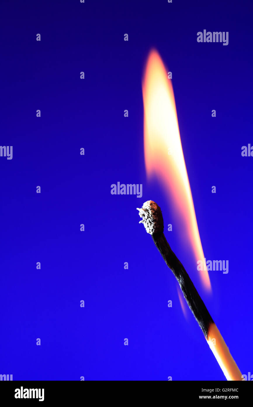 Lighting matchstick on blue background with free space for text Stock ...