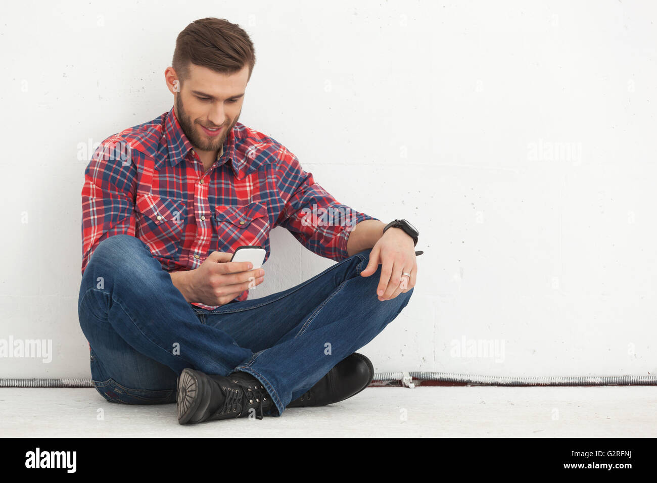 Typing text message.Portrait of handsome young man in casual wear ...