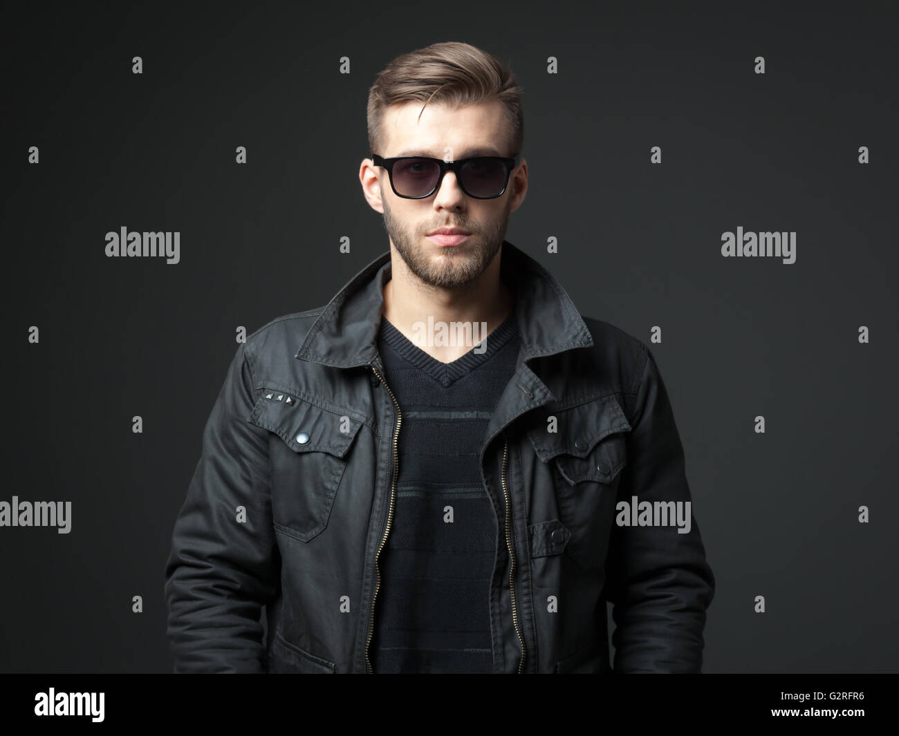 Portrait of cool looking handsome young man in casual wear standing ...