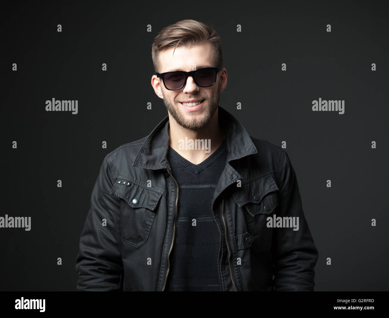 Portrait of cool looking handsome young man in casual wear standing ...
