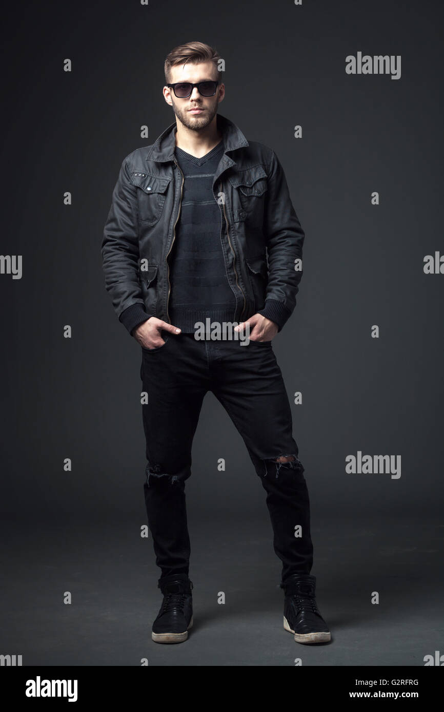 Portrait of cool looking handsome young man in casual wear standing ...