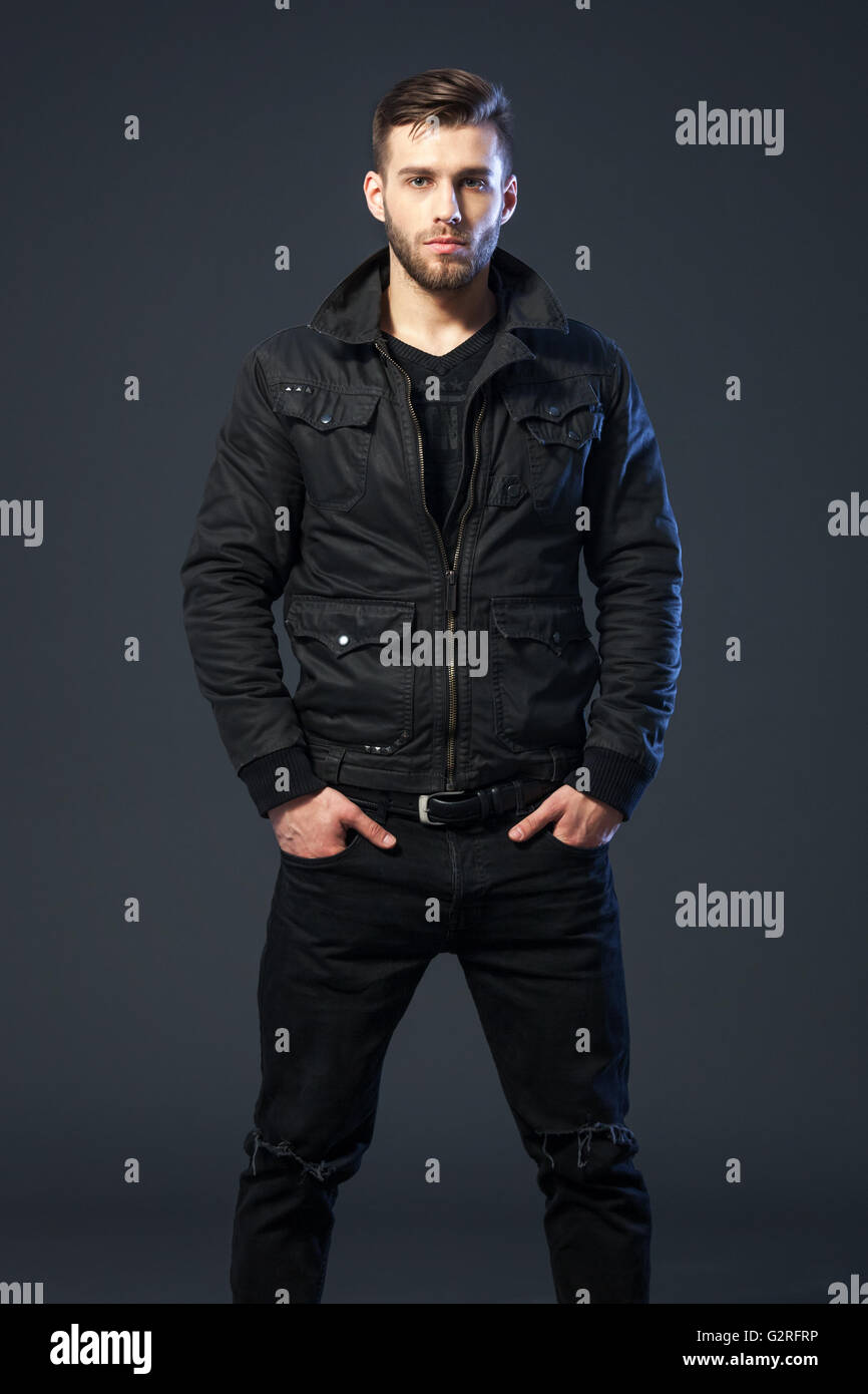 Portrait of cool looking handsome young man in casual wear standing ...