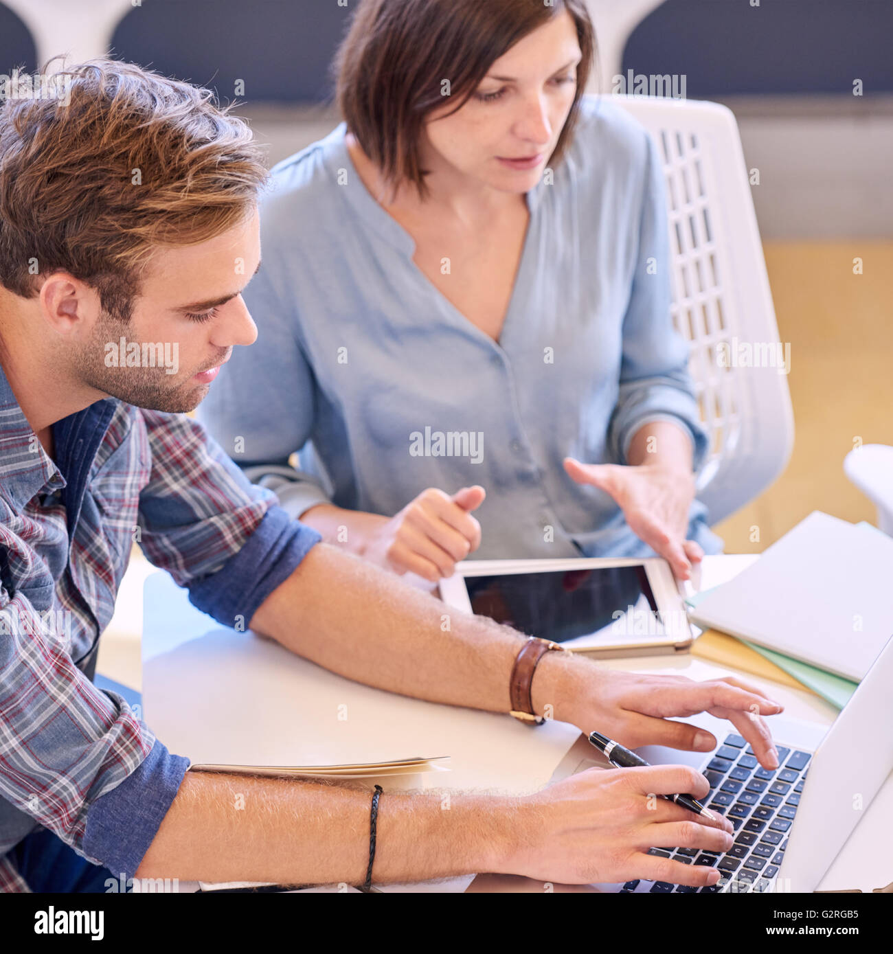 Male and female professional working together to achieve more Stock ...