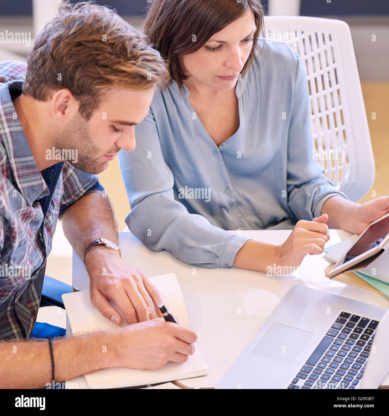 man and woman working together closely at work in office Stock Photo ...