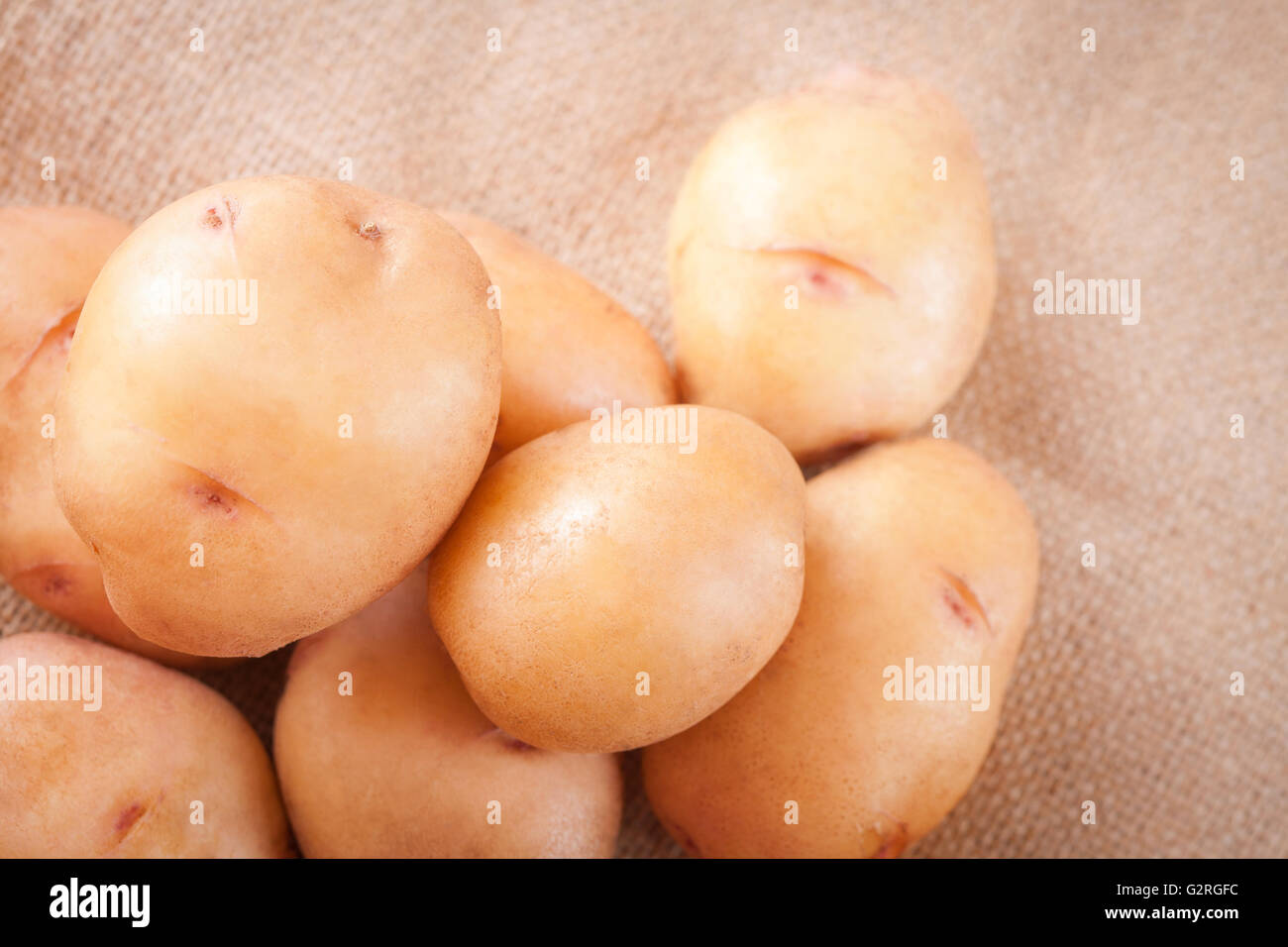 Potato tubers on a table close-up, top view Stock Photo - Alamy