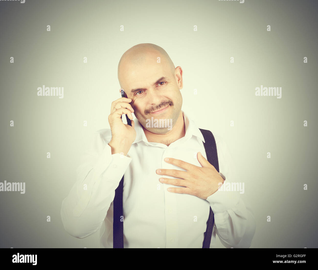 Bald mustachioed man talking on the phone. Emotions Stock Photo - Alamy