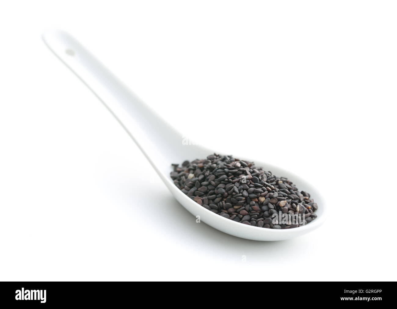 Black sesame seeds. Healthy sesame seeds in ceramic spoon isolated on ...