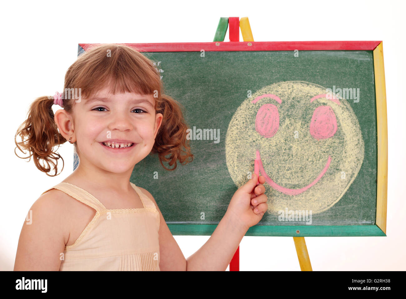 happy little girl drawing smiley face Stock Photo - Alamy