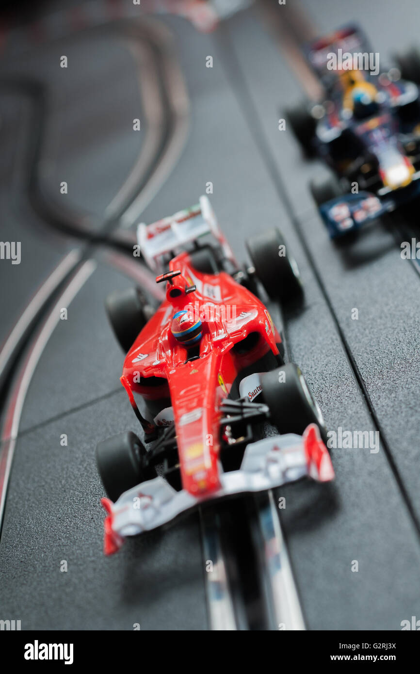 Model formula one style slot cars racing on a track Stock Photo - Alamy