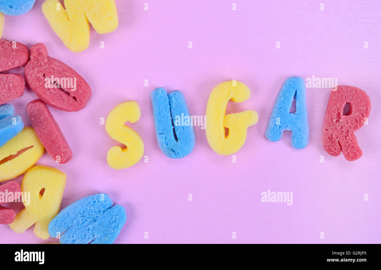 Sugar word on pink wooden table Stock Photo - Alamy