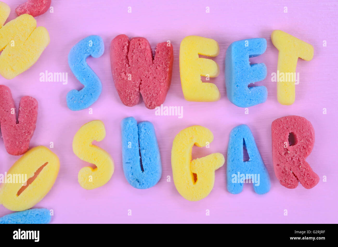 The words Sweet sugar on pink wooden table Stock Photo - Alamy