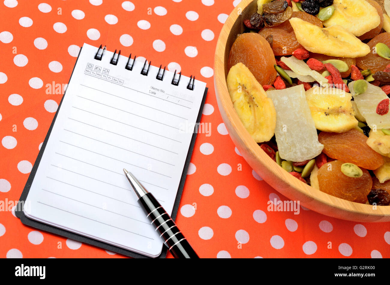 Dried fruits on bamboo bowl with empty notebook Stock Photo - Alamy