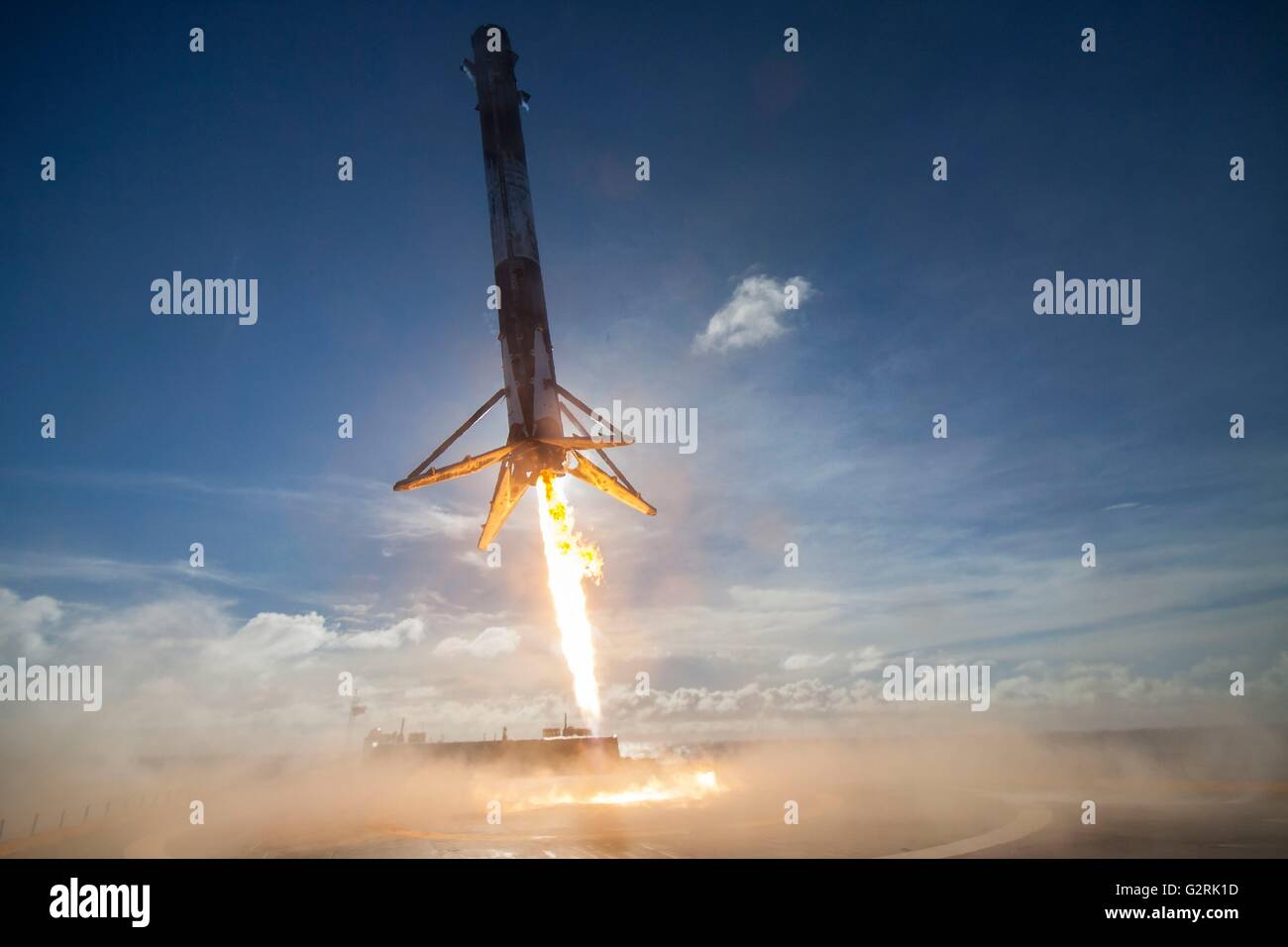 The SpaceX Falcon 9 reusable launch vehicle fires booster rockets as it ...