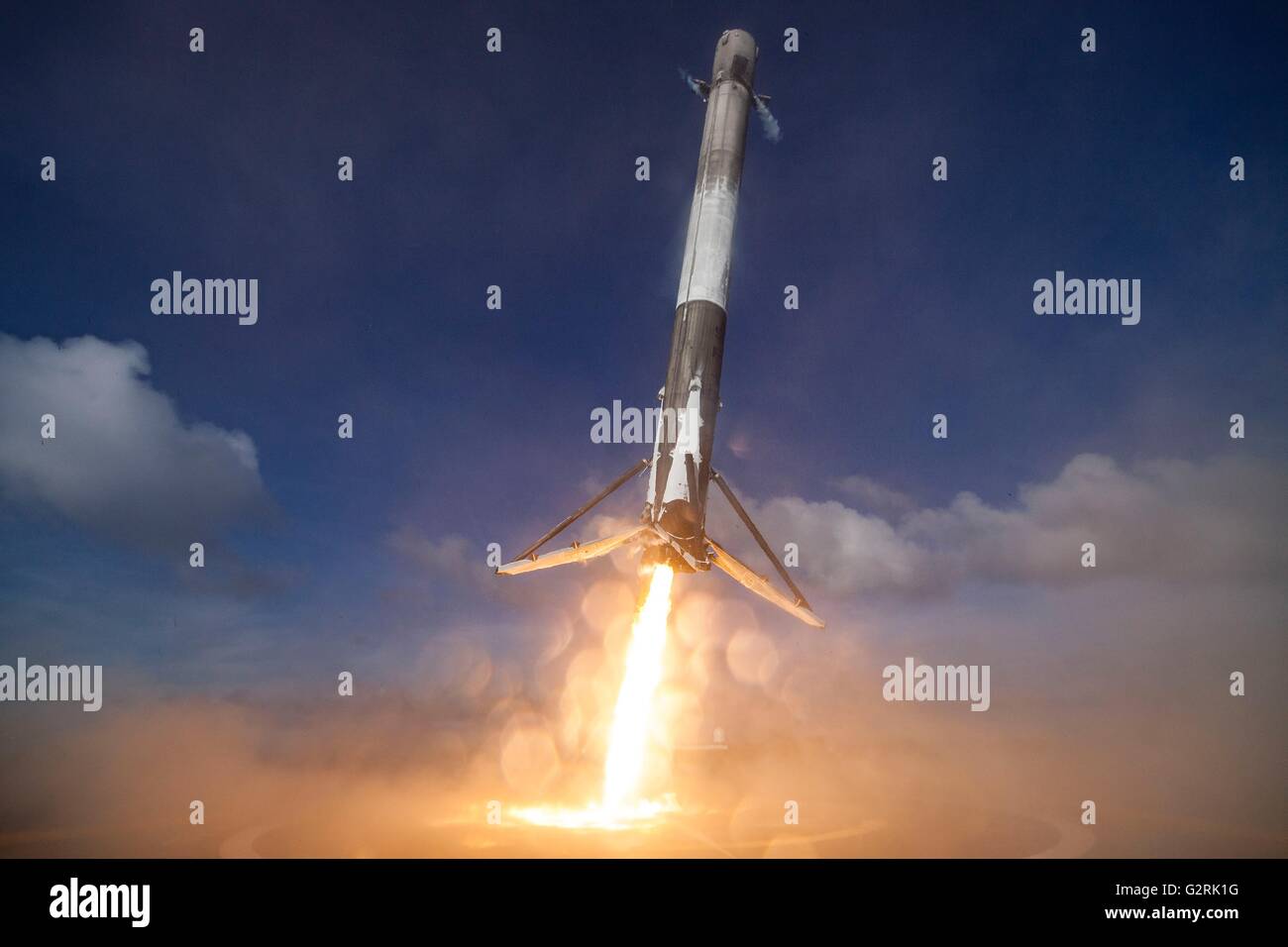 The SpaceX Falcon 9 reusable launch vehicle fires booster rockets as it ...