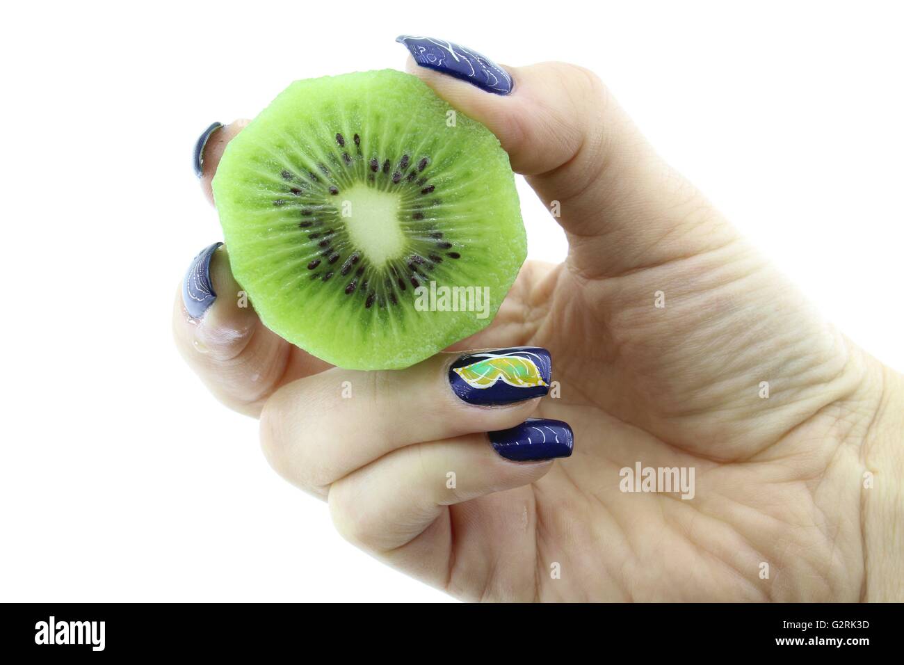 Hand holding half kiwi Stock Photo - Alamy