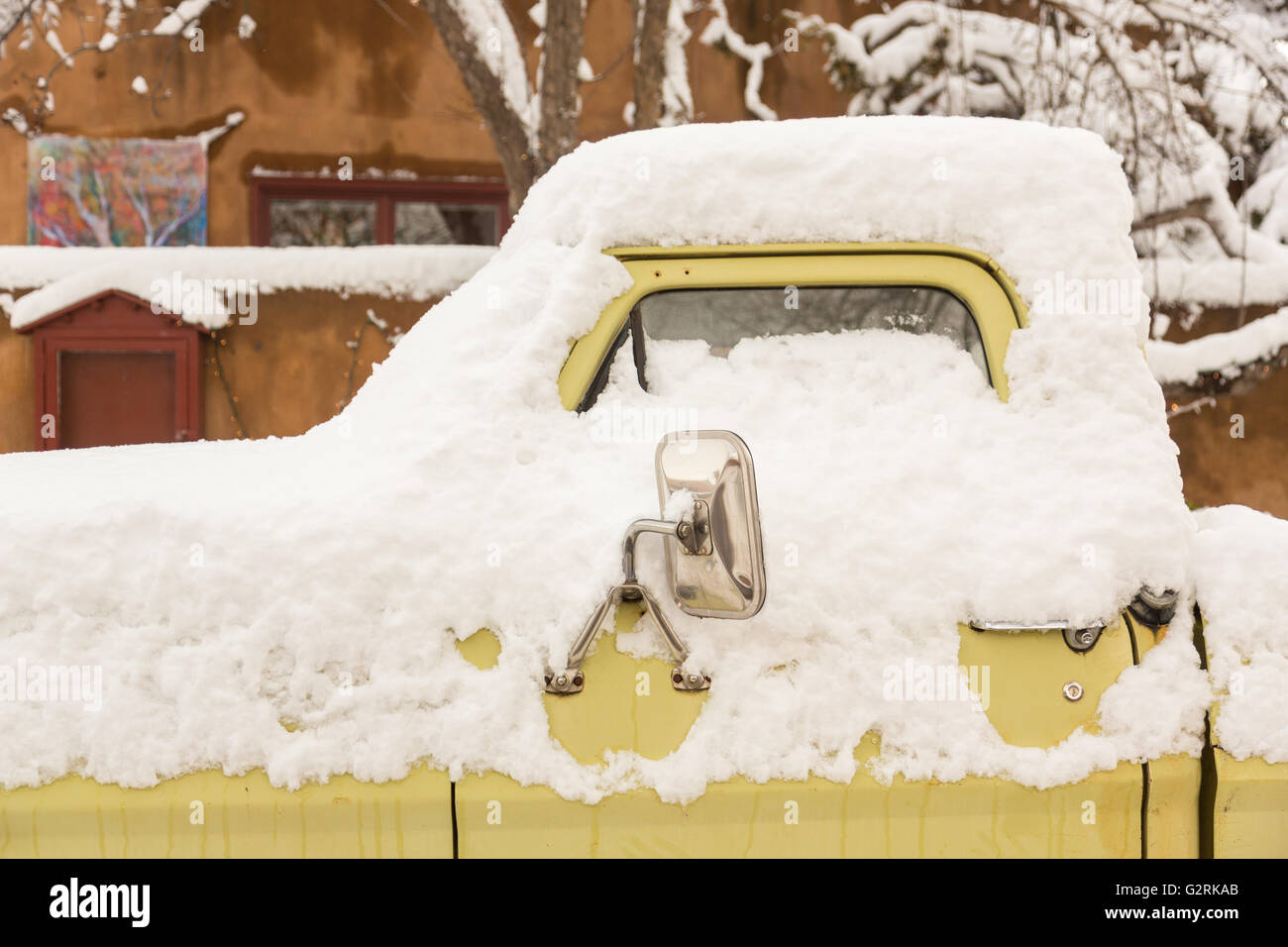 An old yellow pick up truck covered in snow on Canyon Road after a ...