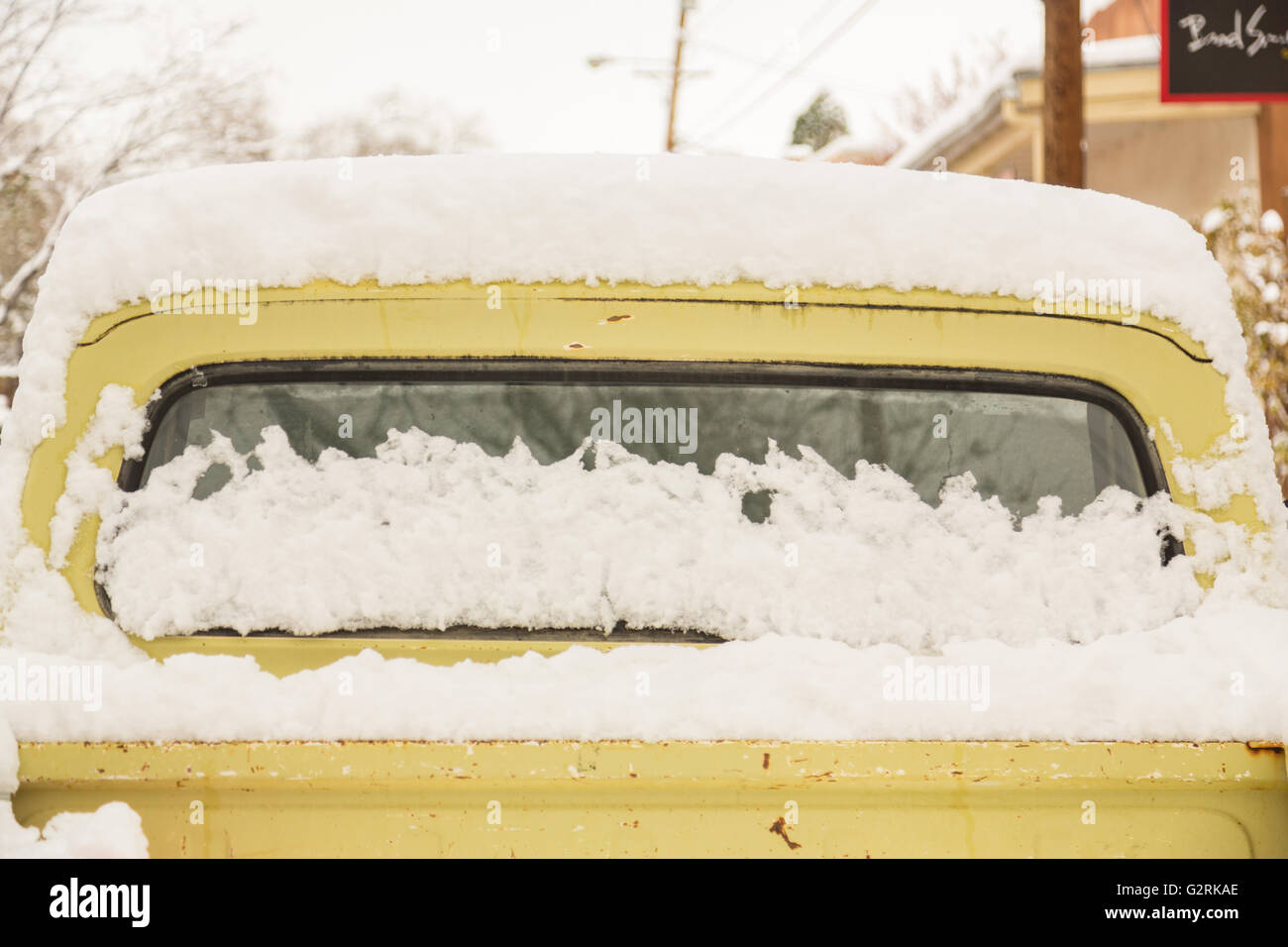 An old yellow pick up truck covered in snow on Canyon Road after a ...
