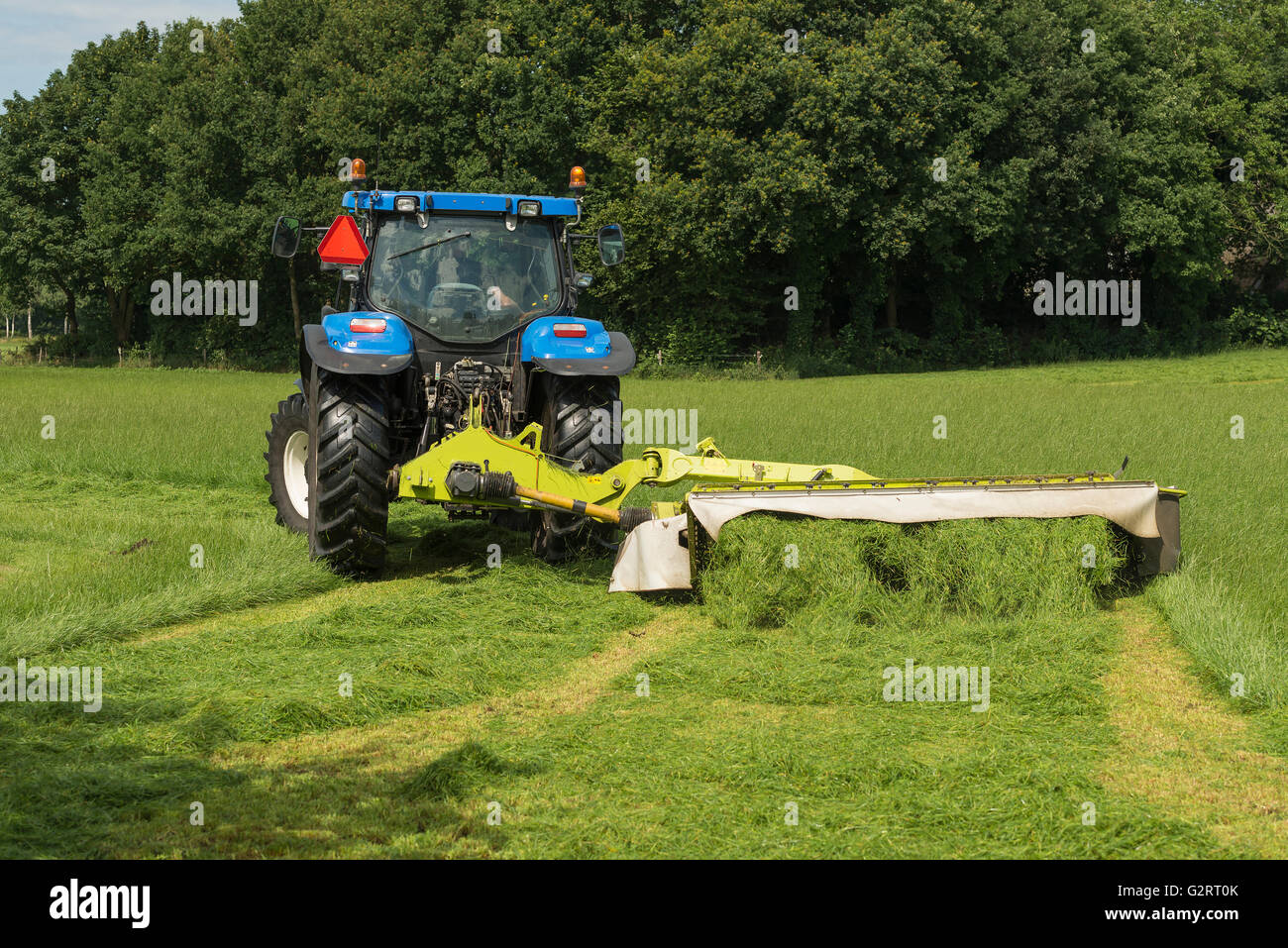 Tractor mowing pasture hi-res stock photography and images - Alamy