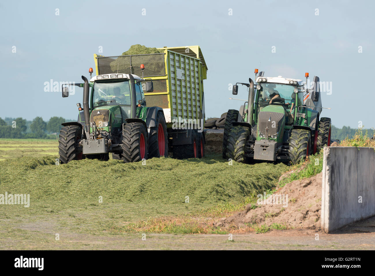 silage with two tractors and a car Stock Photo - Alamy