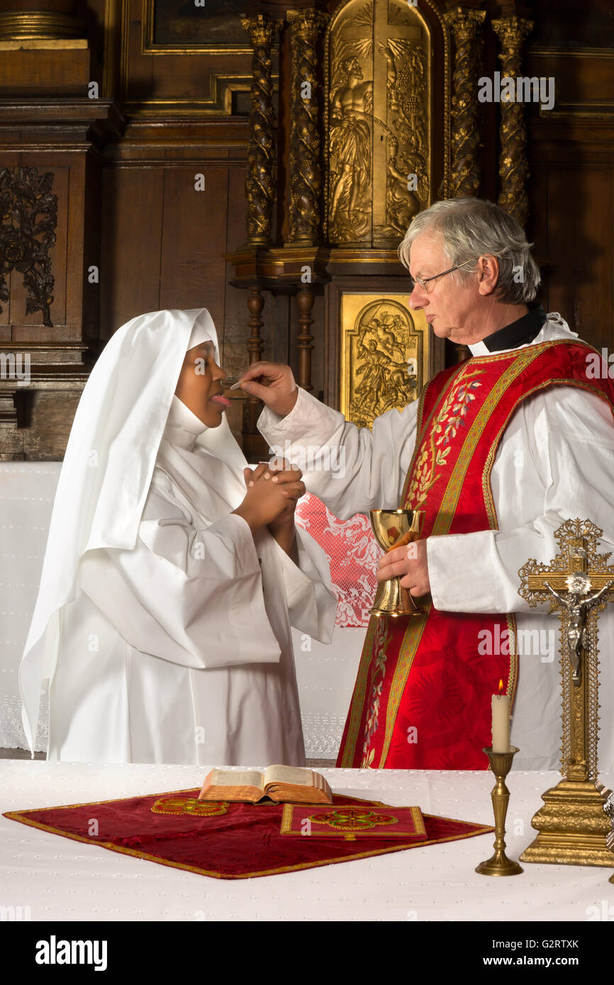 Holy Wafer. Holy communion in church. Taking holy Communion. Priest ...