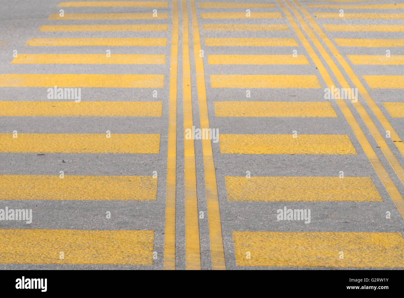 Yellow pedestrian crossing lines on the asphalt surface Stock Photo - Alamy