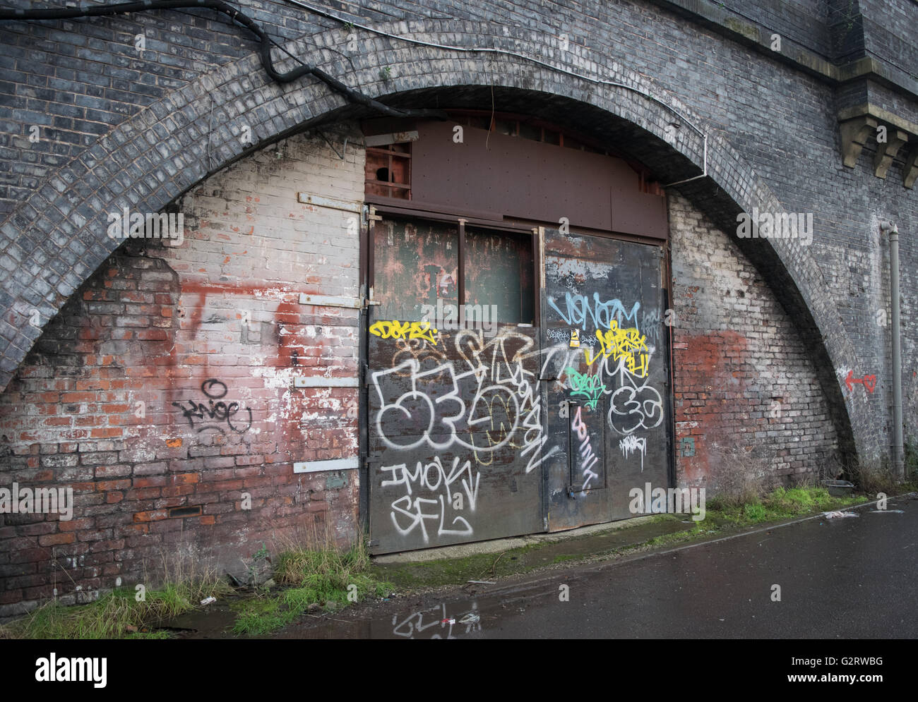 Graffiti covered arch Stock Photo - Alamy