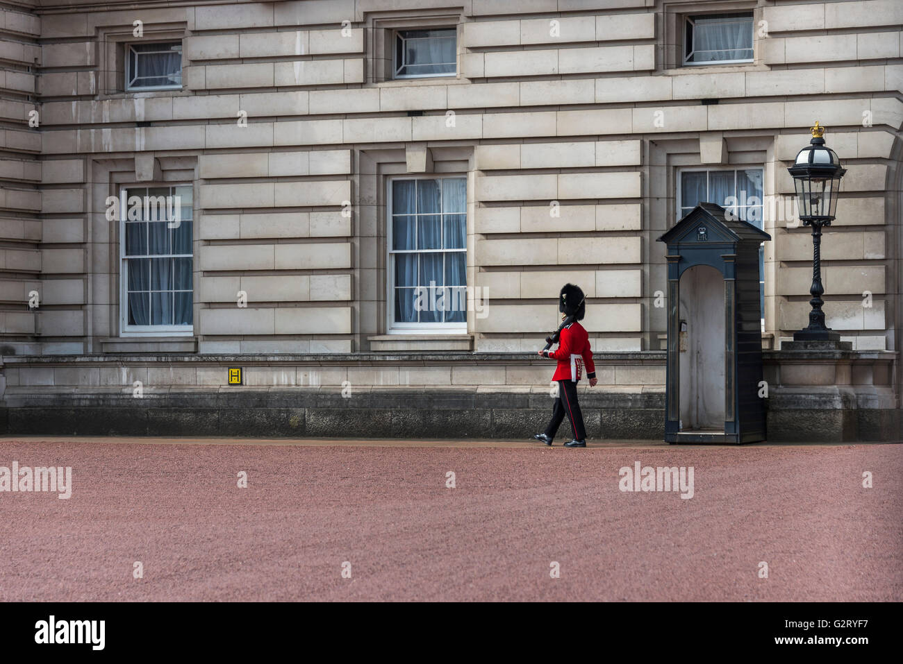 A Queen's Guard Soldier on duty, walking to make his shift with another ...