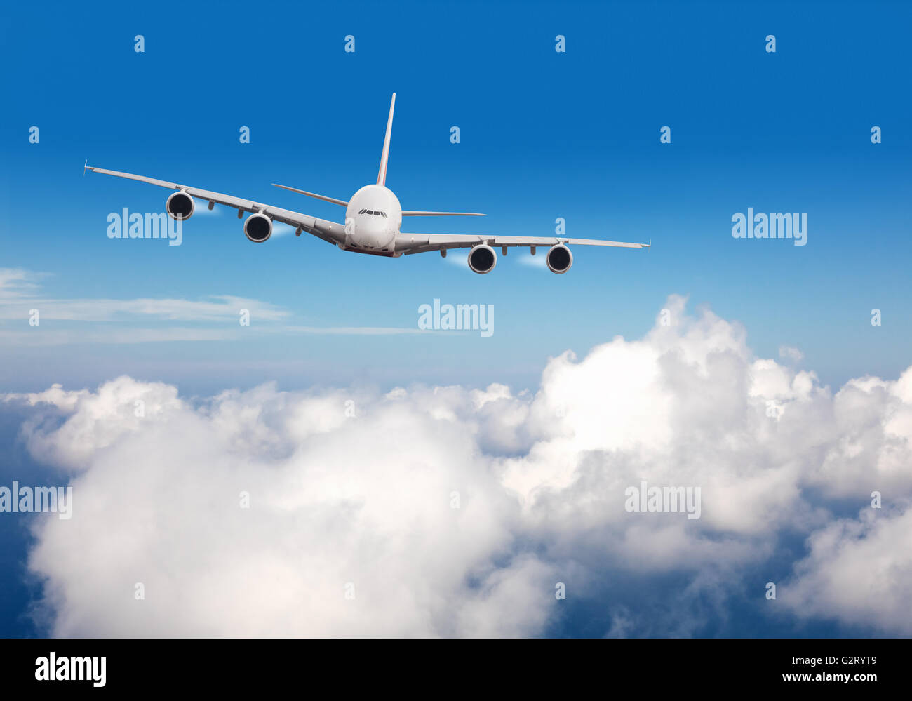 Commercial jet plane flying above clouds in day light Stock Photo - Alamy