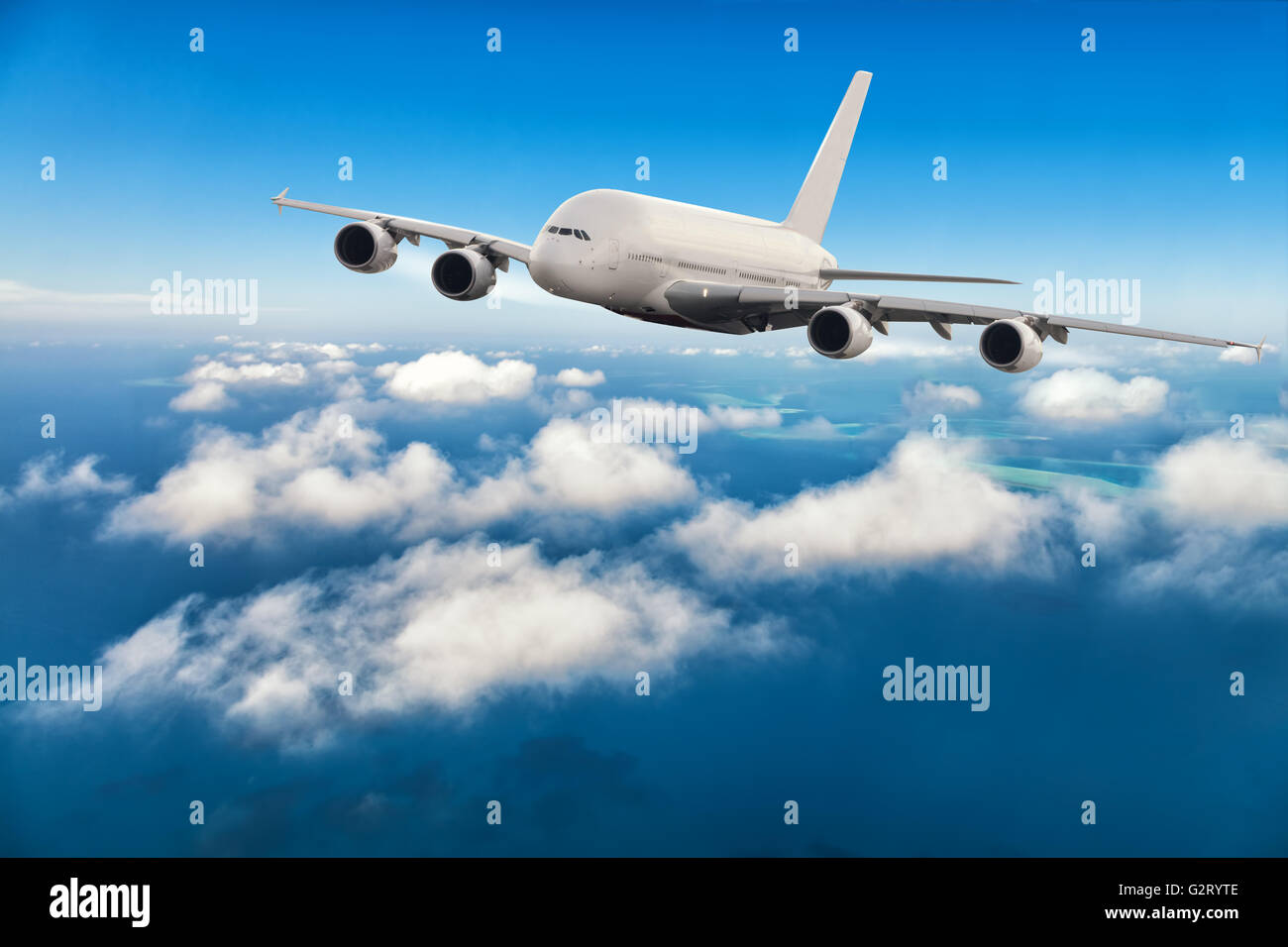 Commercial jet plane flying above clouds in day light Stock Photo - Alamy