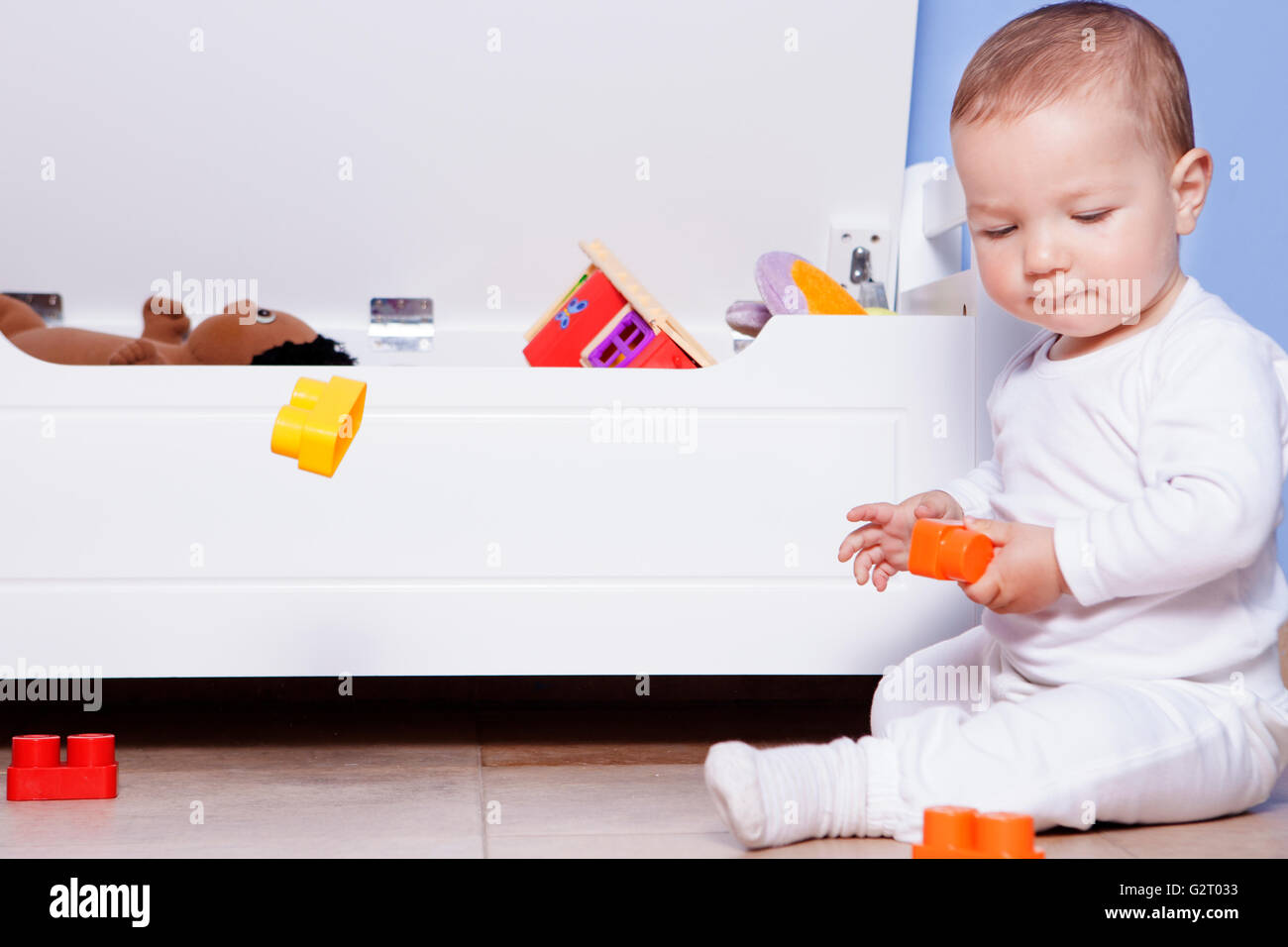 9 month baby boy playing with his white wooden toy trunk Stock Photo ...