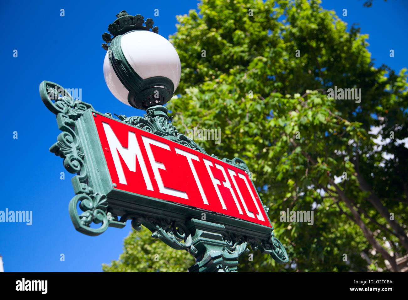 Traditional Paris metro sign with trees in the background Stock Photo ...