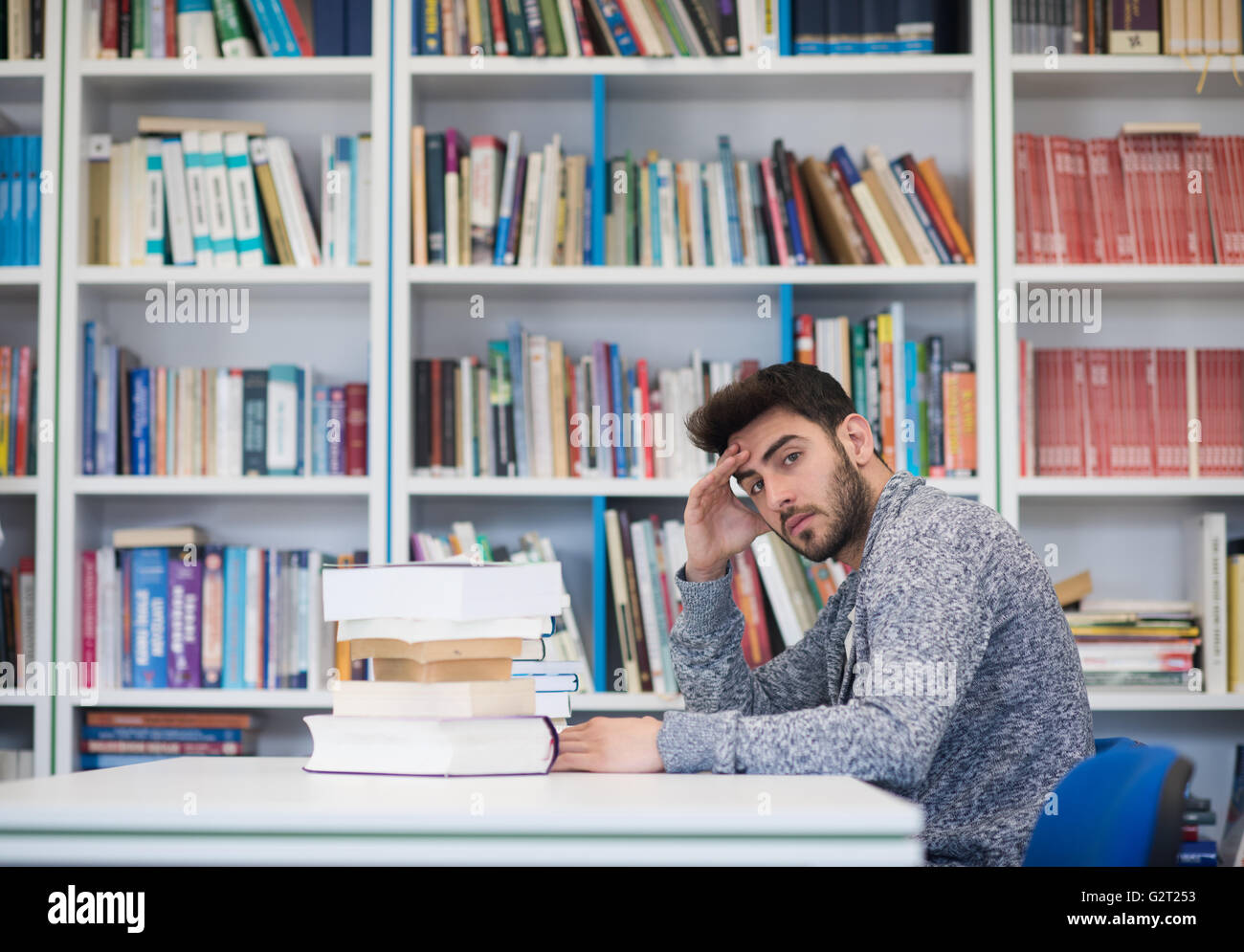 Portrait of happy student while reading book in school library. Study ...
