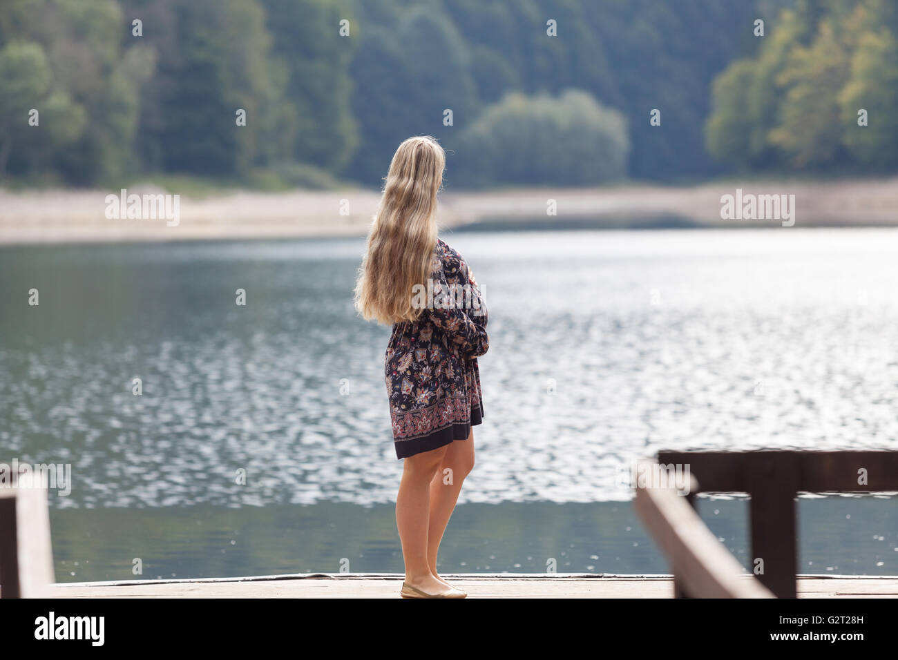 Young beautiful woman posing at the lake Stock Photo - Alamy