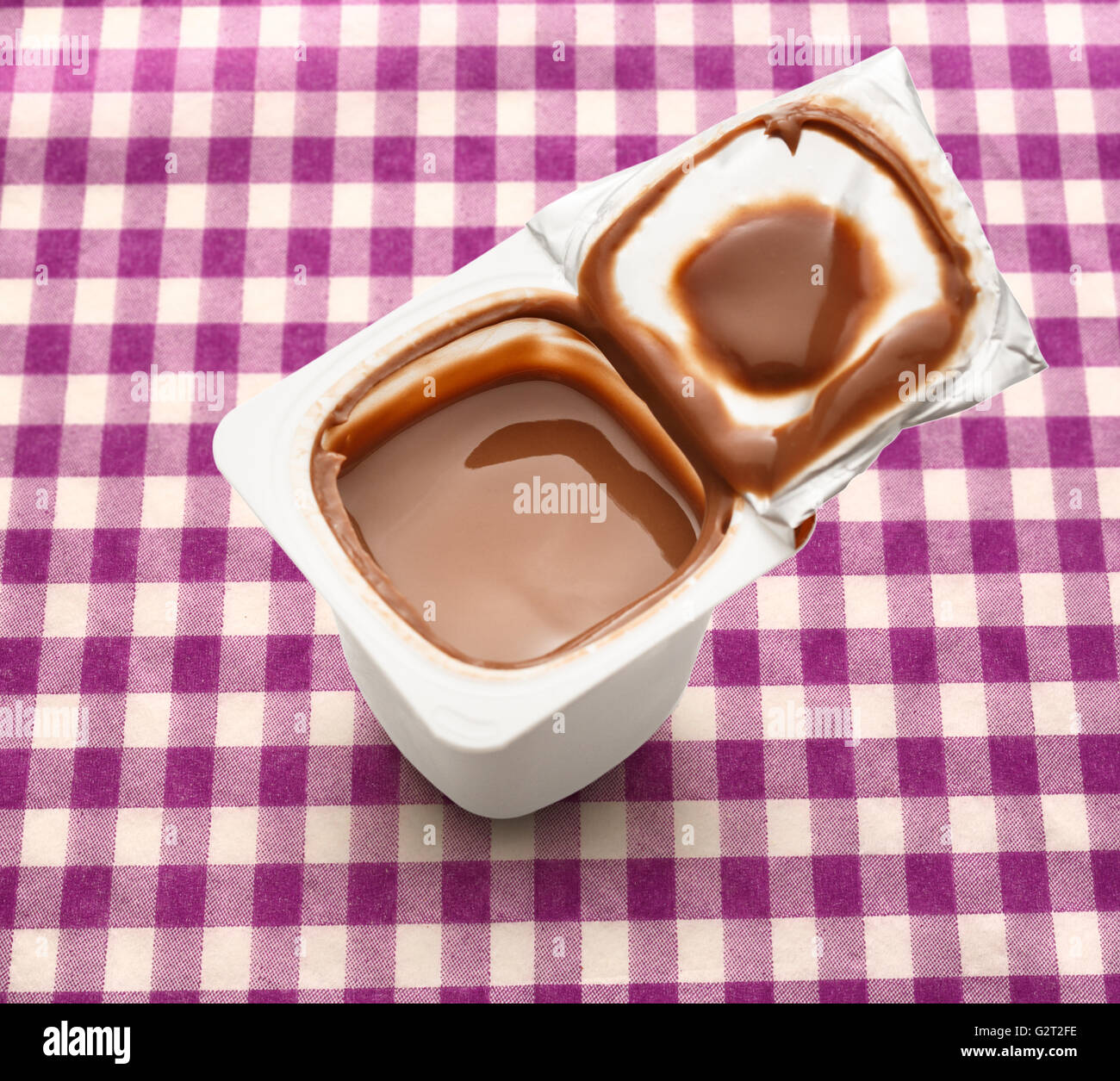 Open yogurt in pot on fabric background in closeup Stock Photo - Alamy