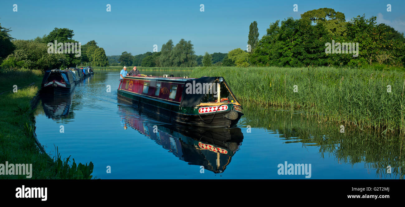 Two people on Narrowboat in summer at Tixall Wide on the Staffordshire ...