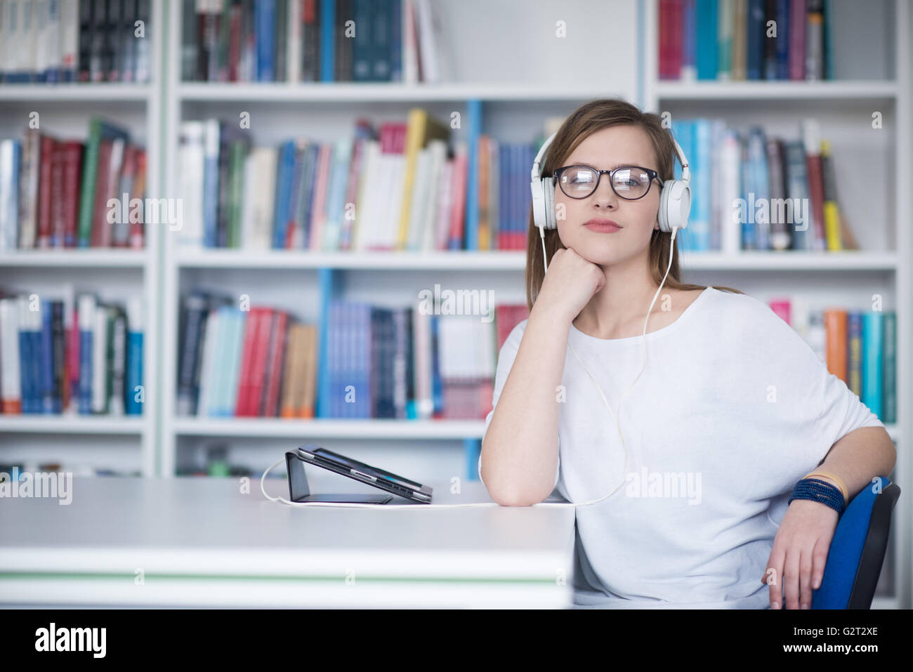 female student study in school library, using tablet and searching for ...