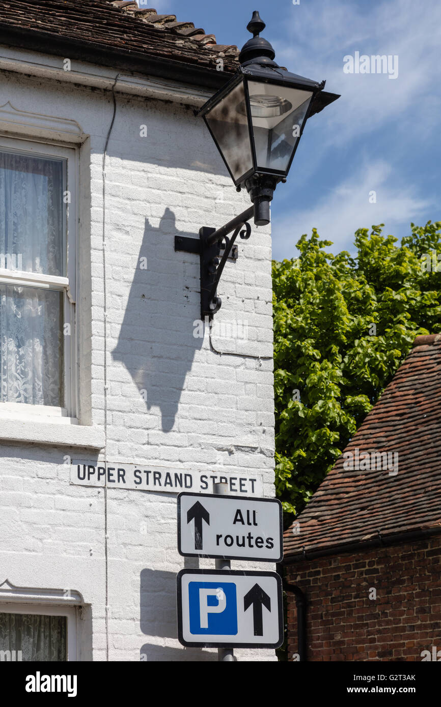 Old fashioned street light and road signs on the corne of an historic ...