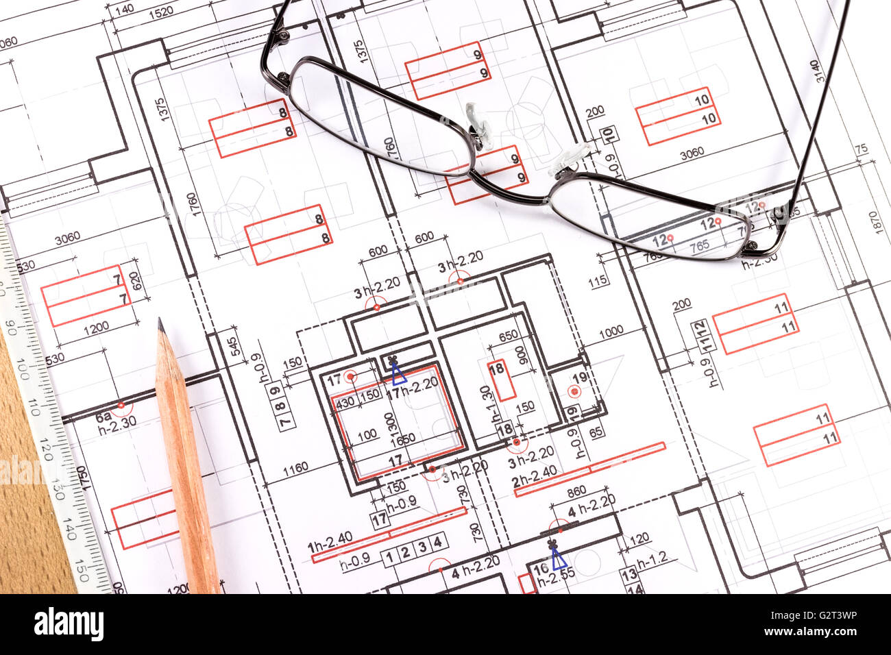 Eyeglasses and architectural drawings tools on construction blueprint ...