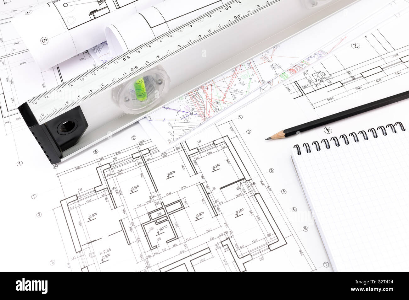 Architectural blueprints of new homes, spirit level and notepad with ...