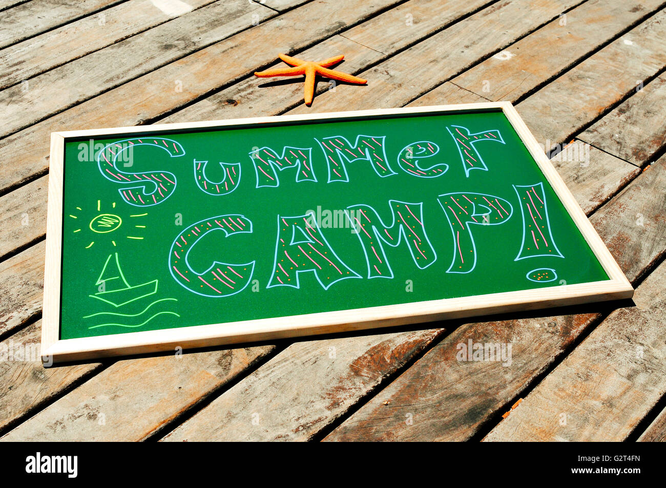 the text summer camp written with chalk of different colors in a ...