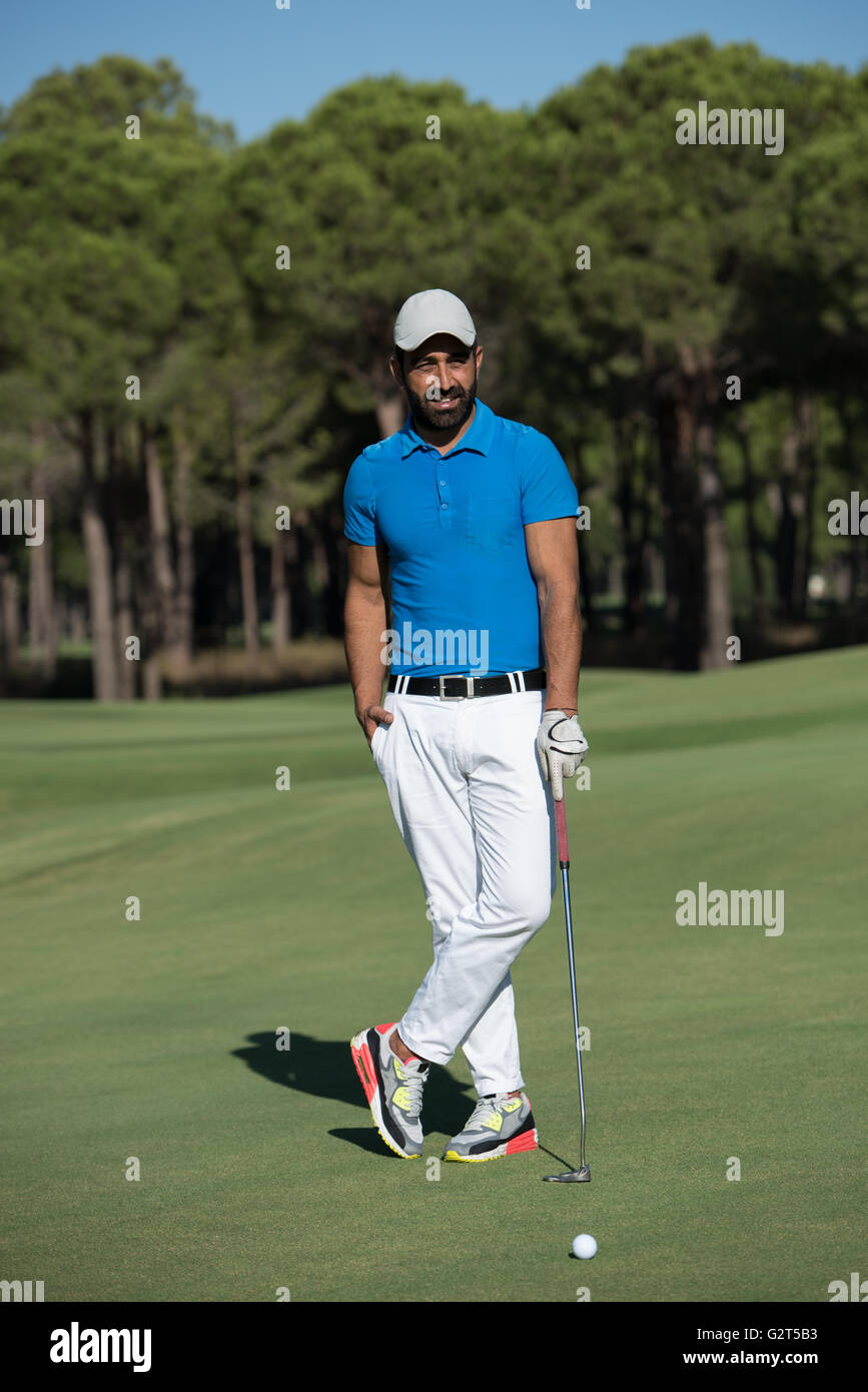 handsome middle eastern golf player portrait at course at sunny day ...