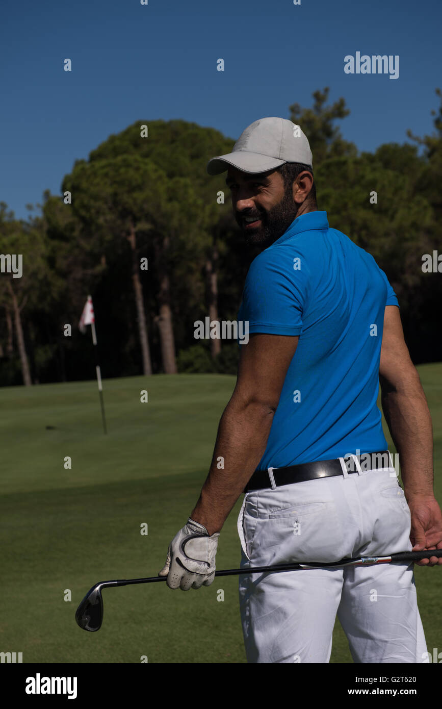 handsome middle eastern golf player portrait from back with course in ...