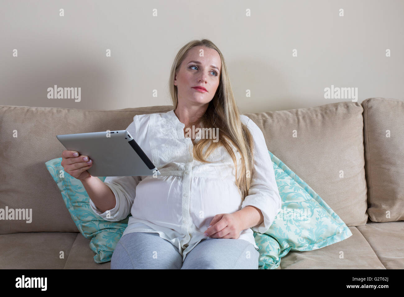 pregnant woman spends time with the tablet Stock Photo - Alamy
