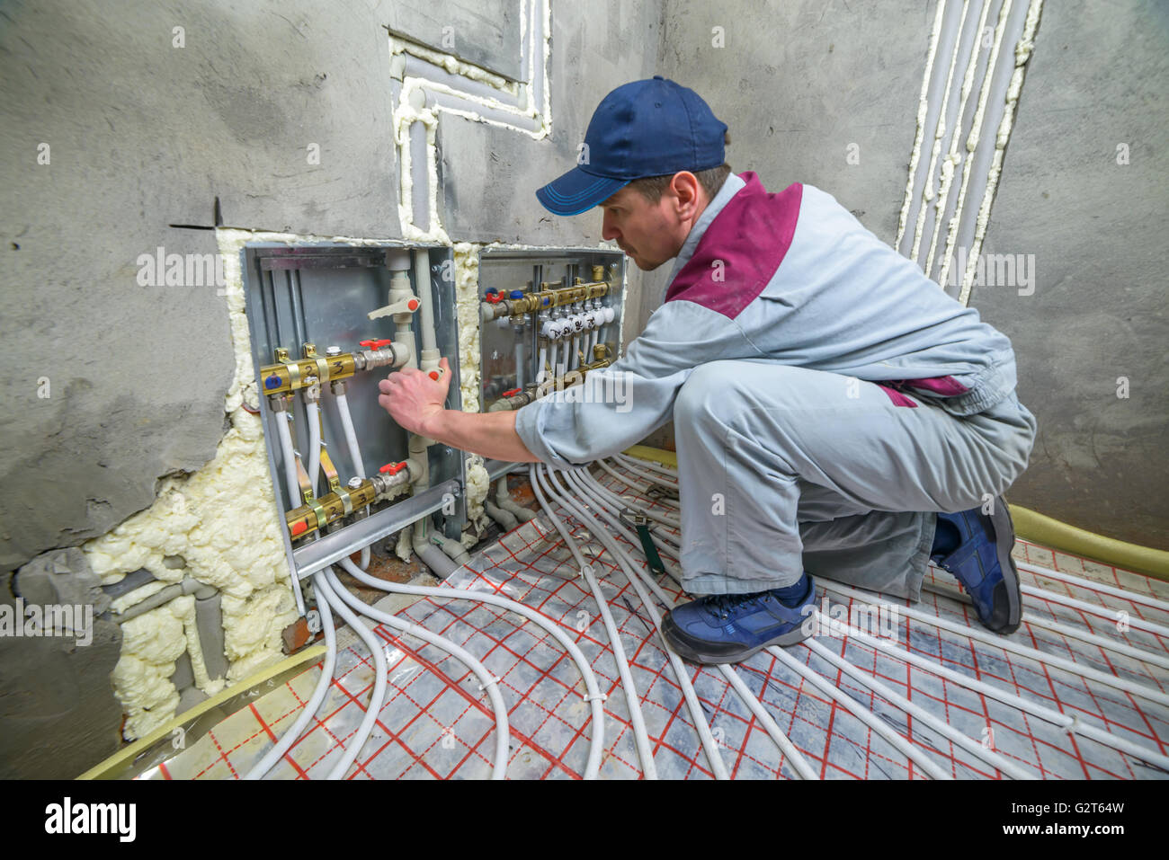 pipefitter installing system of heating Stock Photo - Alamy