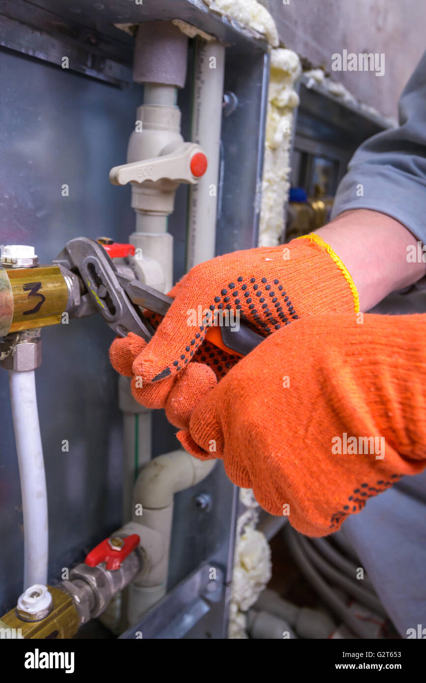 pipefitter installing system of heating Stock Photo - Alamy