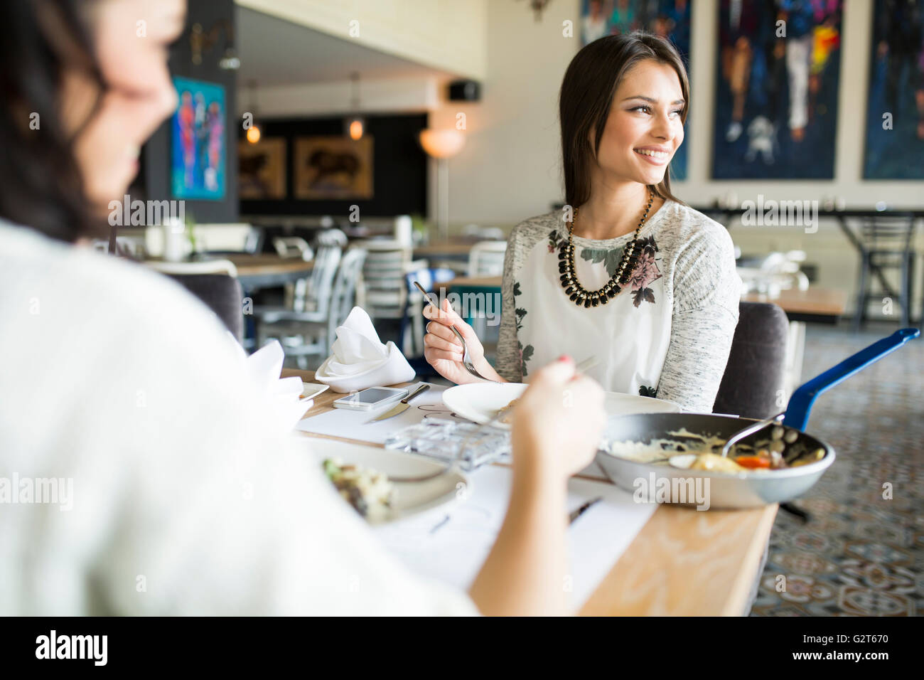 Women at the table in the restaurant Stock Photo - Alamy