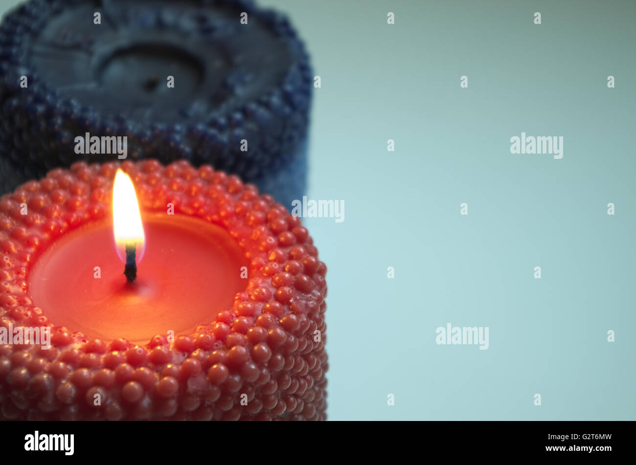 Candlelit background. Red and blue candles closeup Stock Photo - Alamy